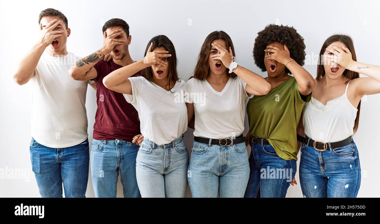 Group of young friends standing together over isolated background ...