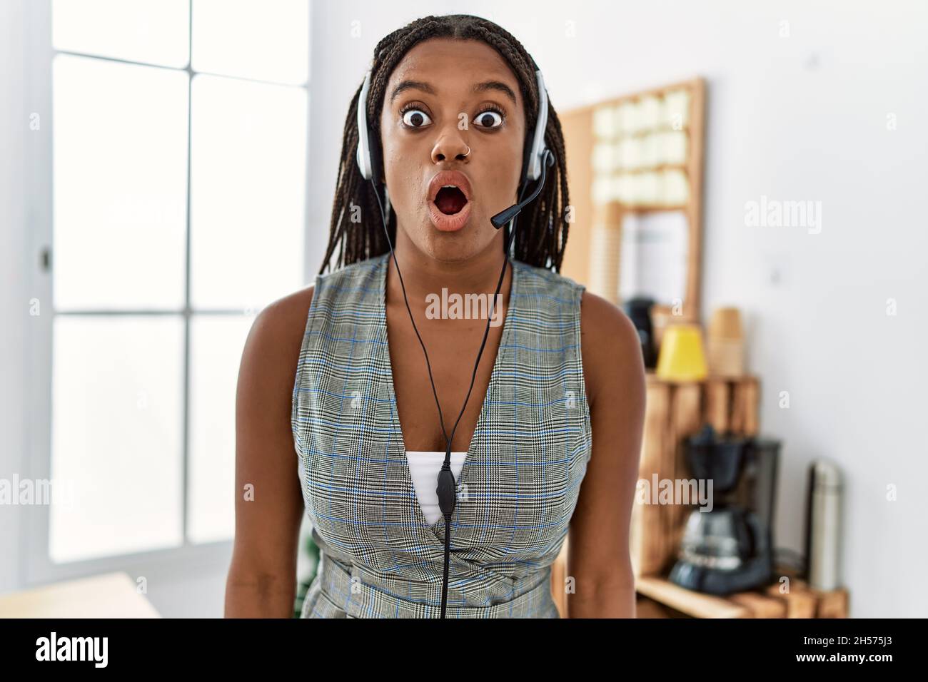 Young african american woman working at the office wearing operator ...