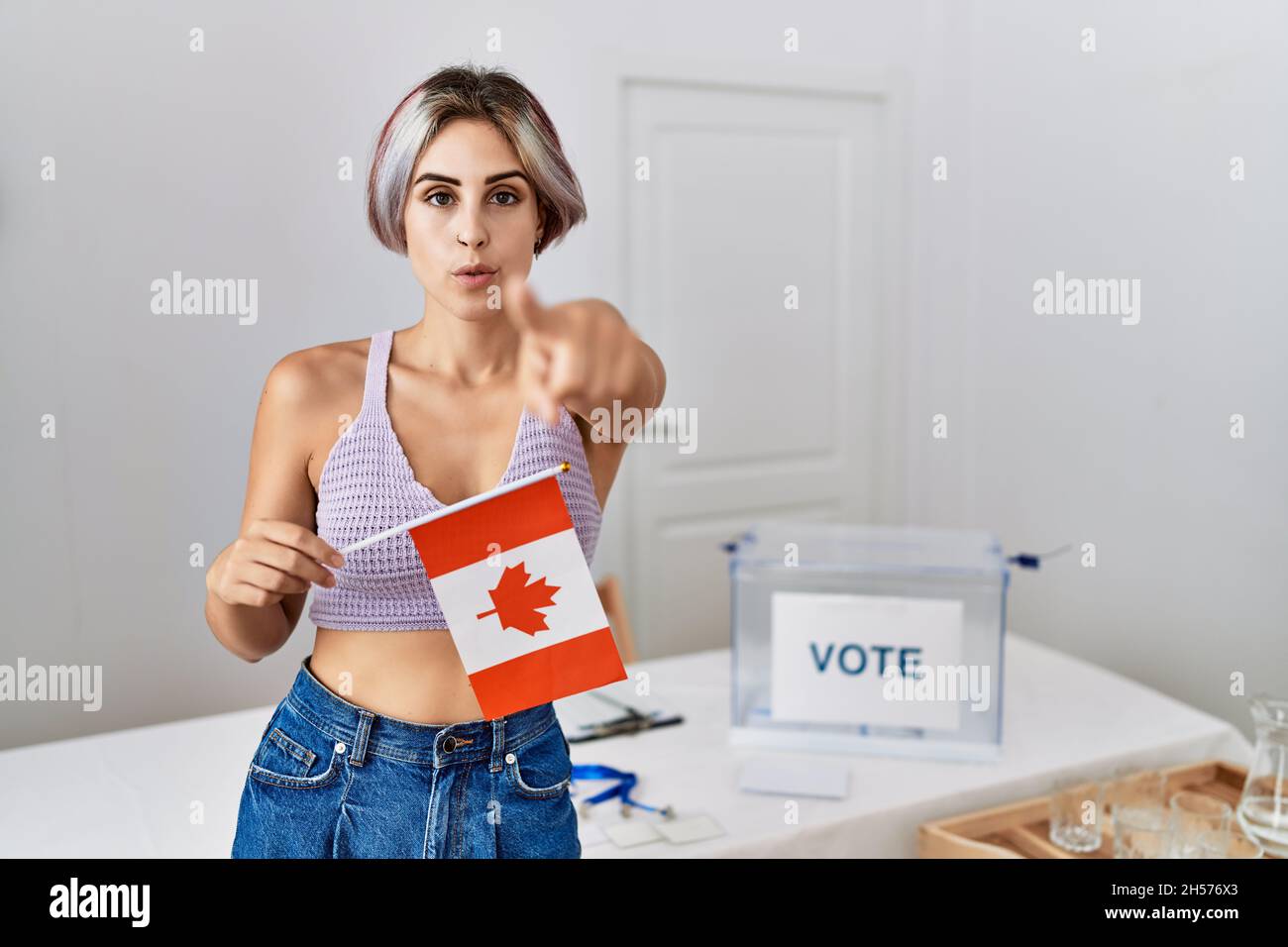 Young beautiful woman at political campaign election holding canada ...