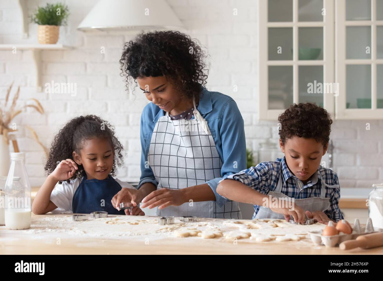 Cute little Black kids helping mom to bake cookies Stock Photo - Alamy