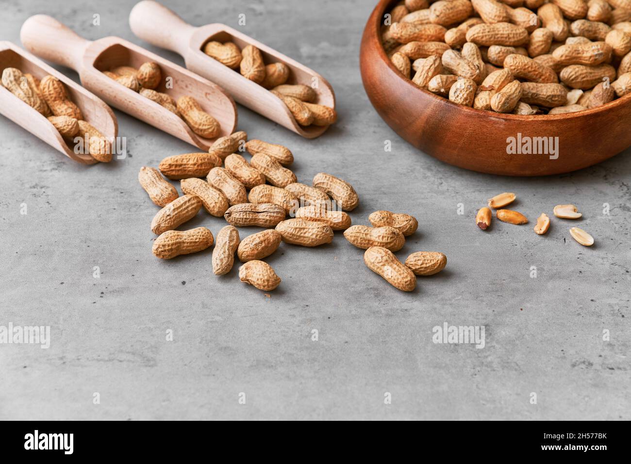 Image of wooden spoons with peanuts on a concrete surface Stock Photo ...