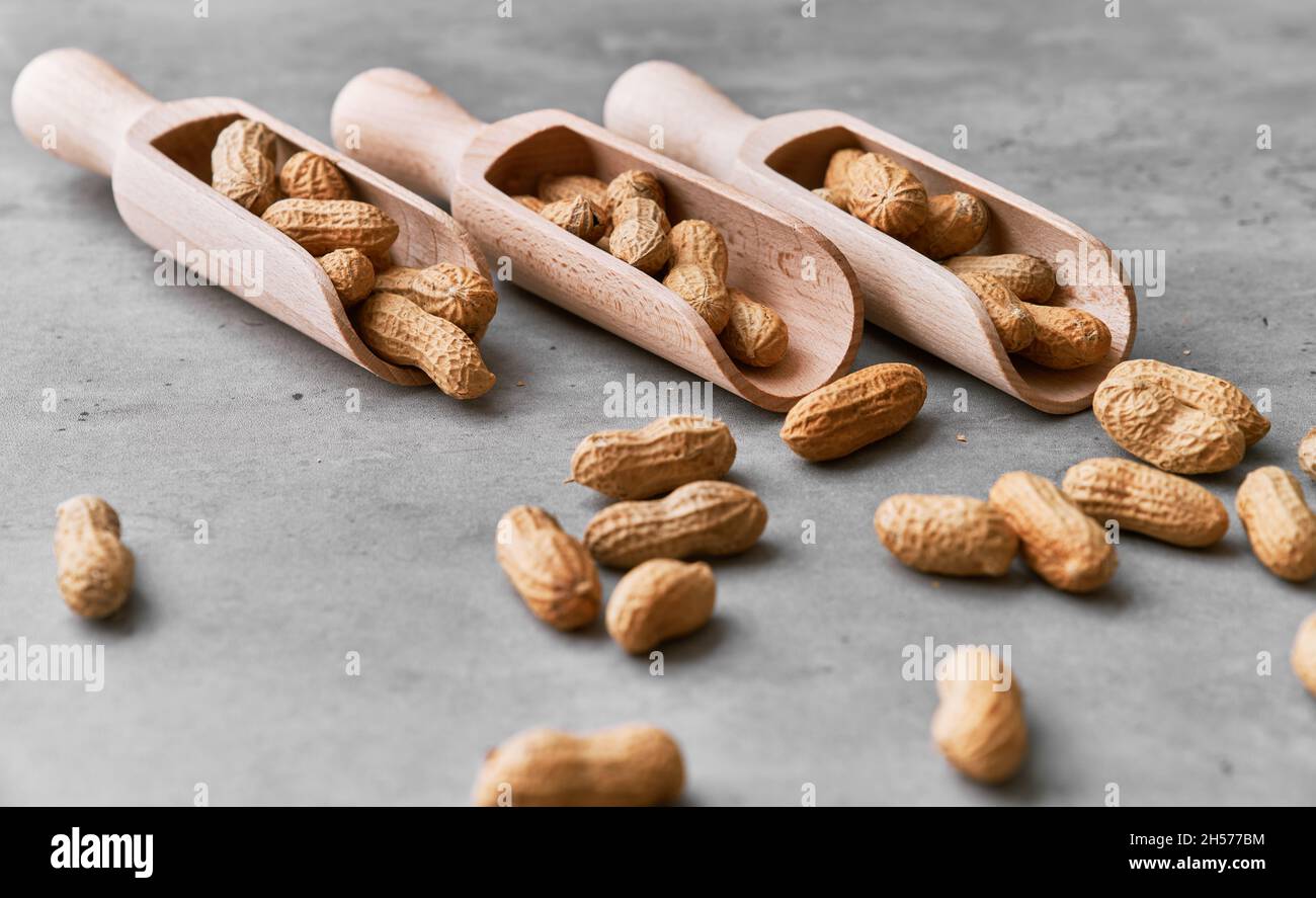 Image of wooden spoons with peanuts on a concrete surface Stock Photo ...