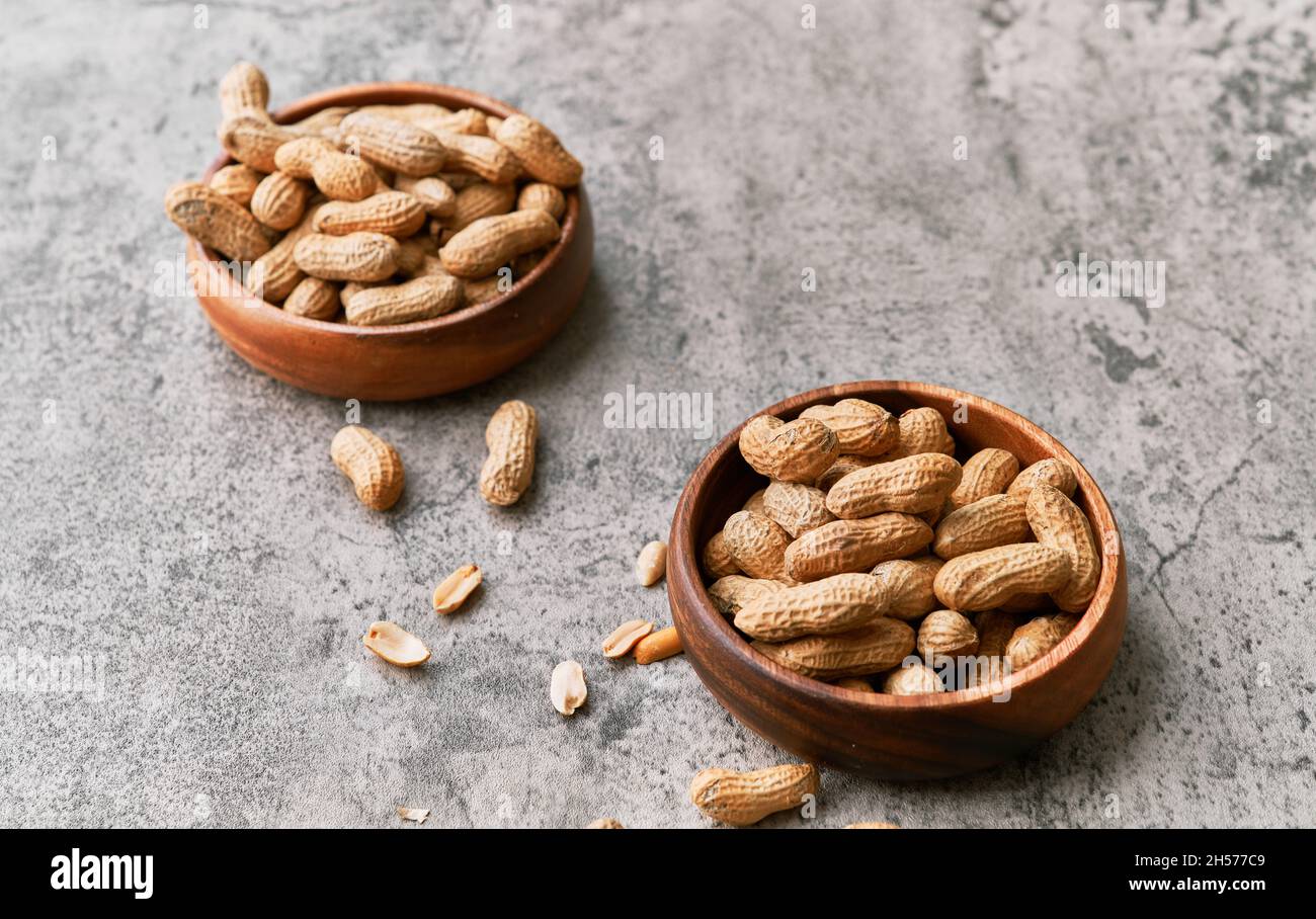 Image of bunch of peanuts in a bowl on a concrete surface Stock Photo ...
