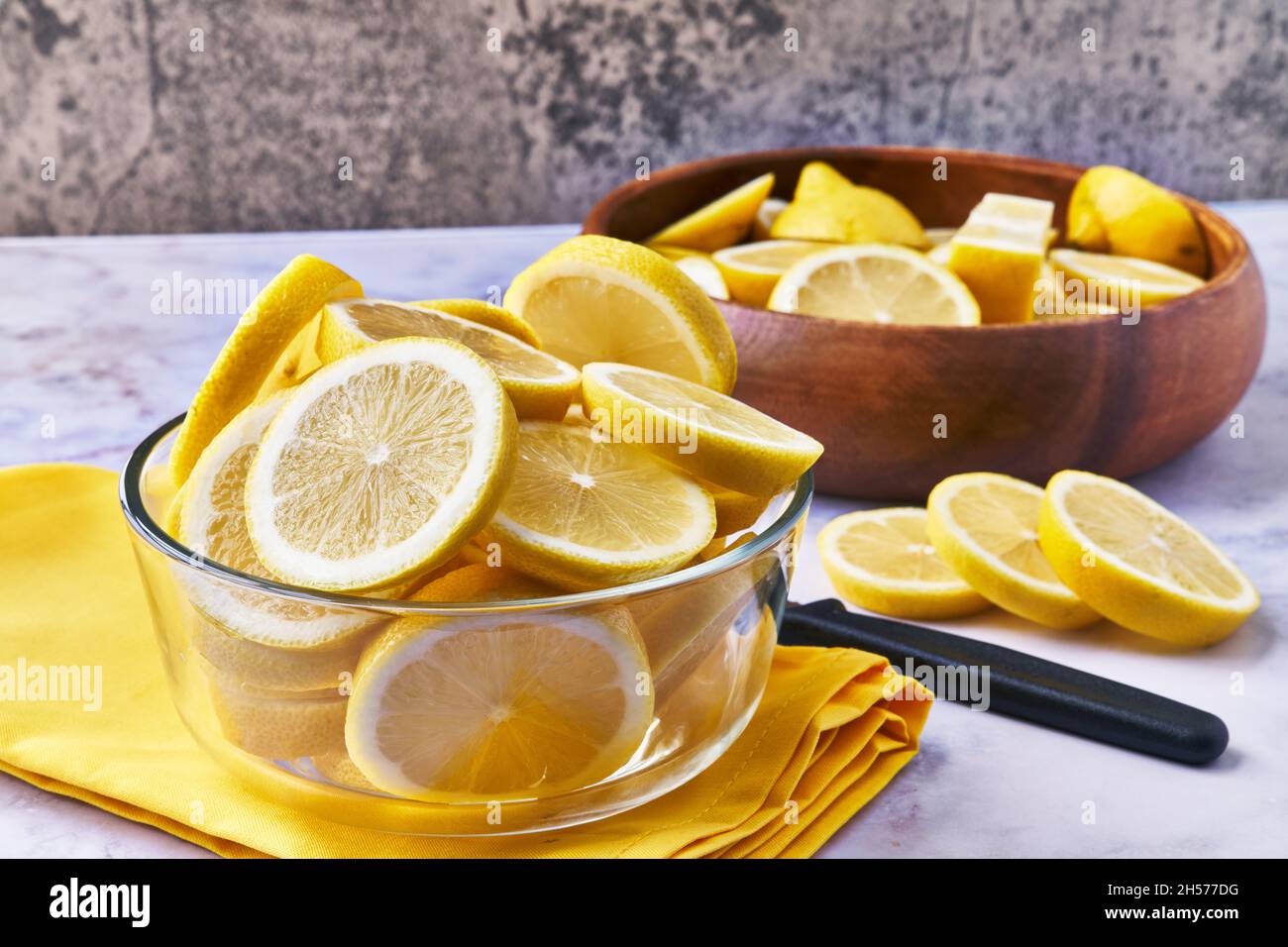 Bowls of slices of lemon on a marble surface Stock Photo - Alamy