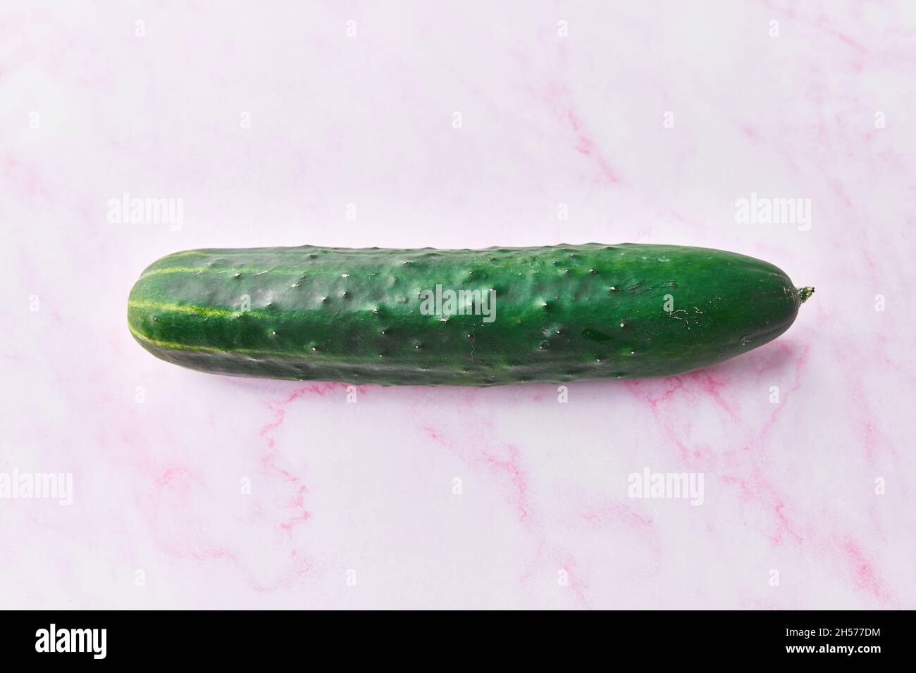 Single cucumber on a marble surface Stock Photo - Alamy