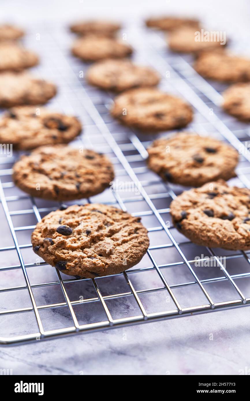 Chocolate cookies served on a grid rack on a marble table Stock Photo ...