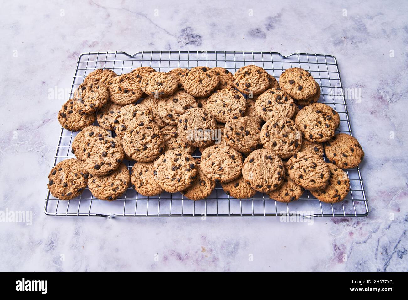 Chocolate cookies served on a grid rack on a marble table Stock Photo ...