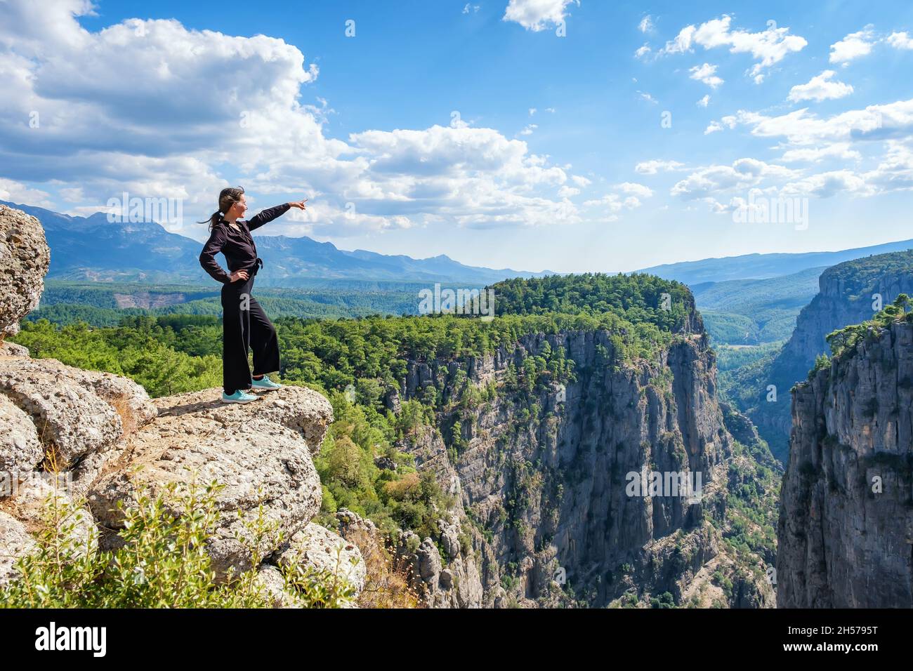 Woman standing rocky cliff hi-res stock photography and images - Alamy