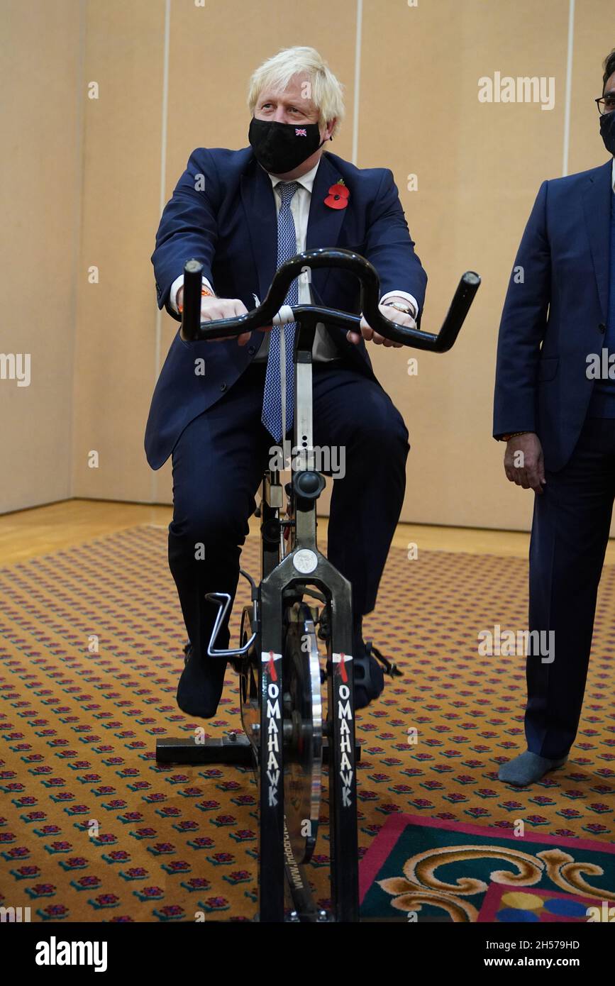 Prime Minister Boris Johnson on an exercise bike as he meets voluteers ...