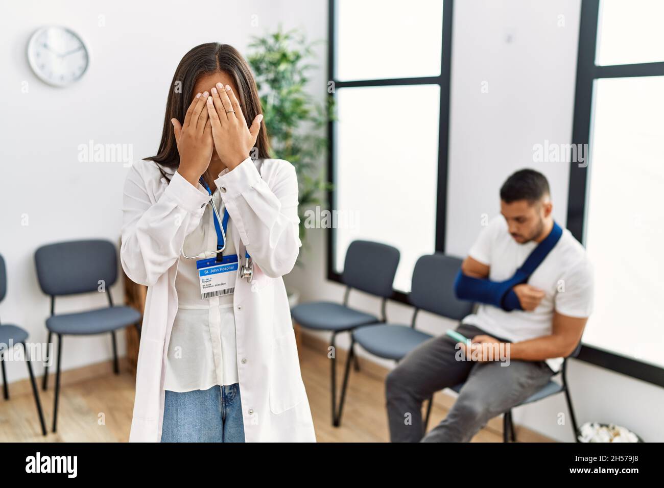 Young asian doctor woman at waiting room with a man with a broken arm ...