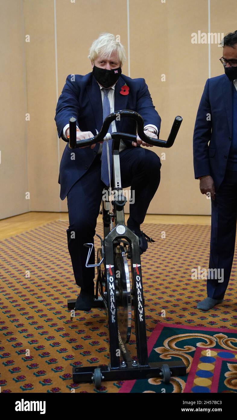 Prime Minister Boris Johnson on an exercise bike as he meets voluteers ...
