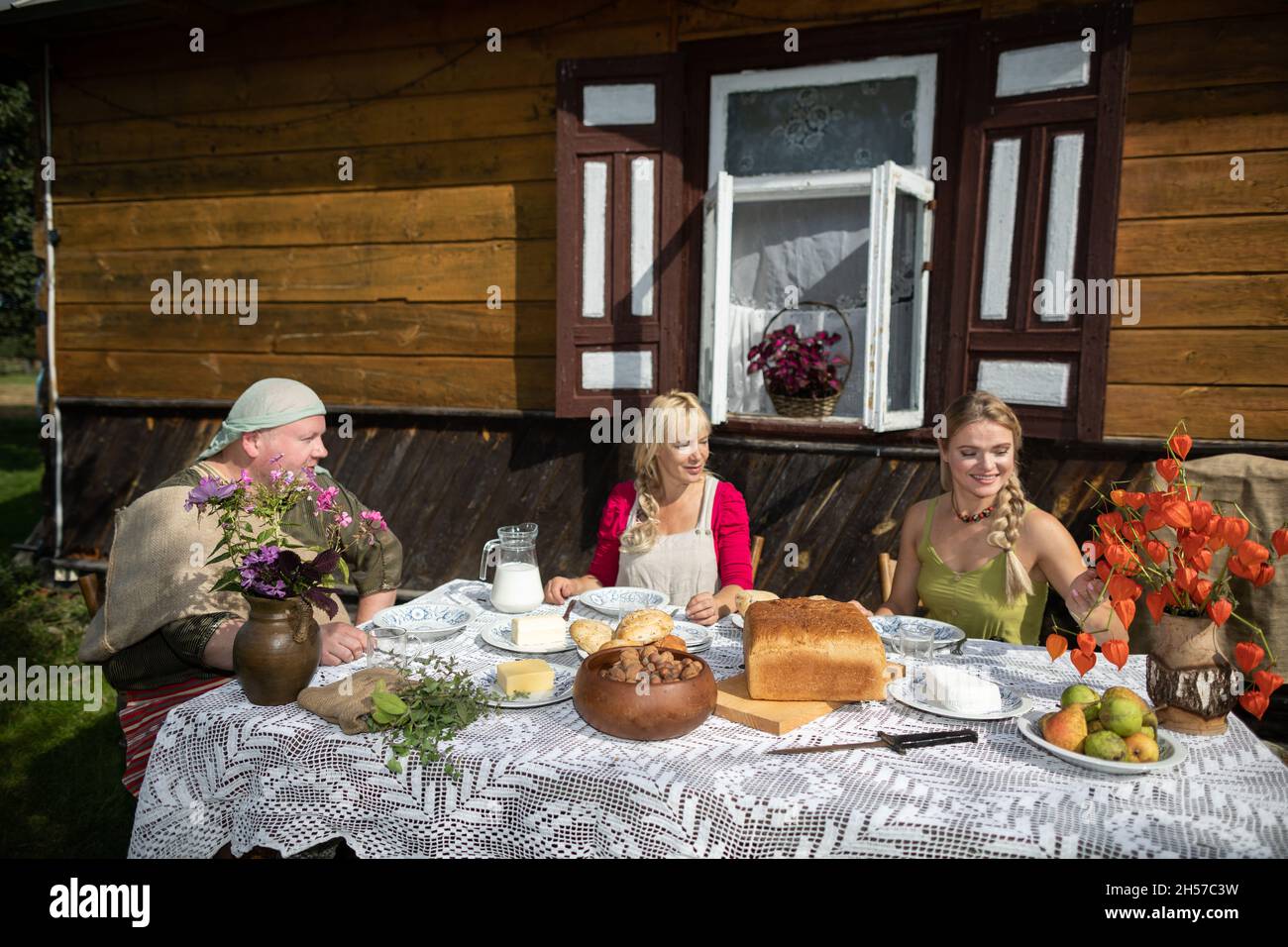 A conversation at a village table between two women of different ages ...