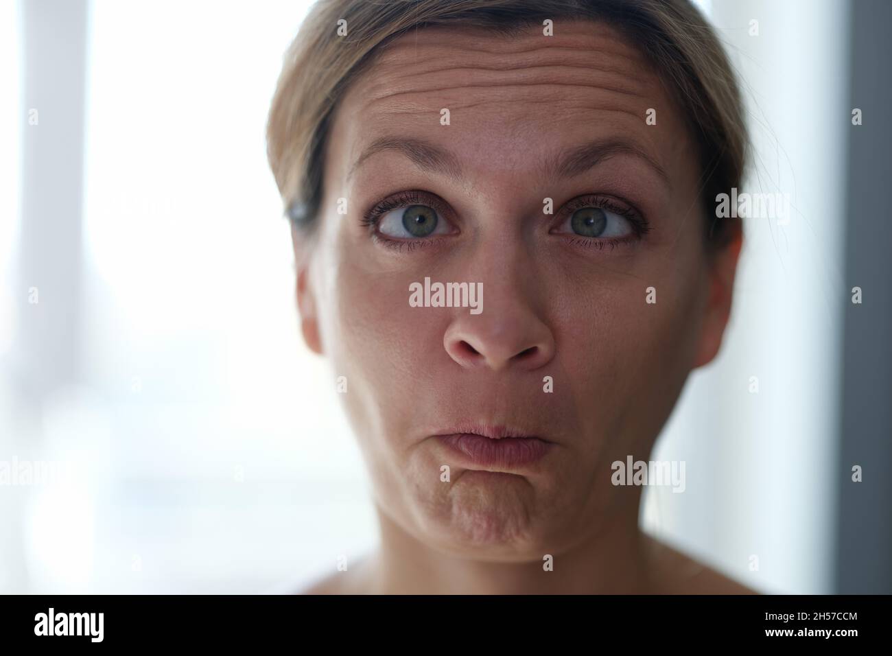 Silly facial expression, woman grimacing, close-up Stock Photo - Alamy