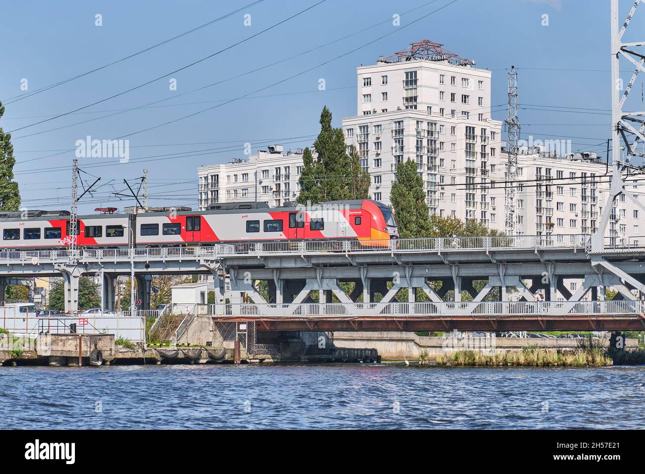 Electric train Lastochka going on two-tier railway bridge across ...