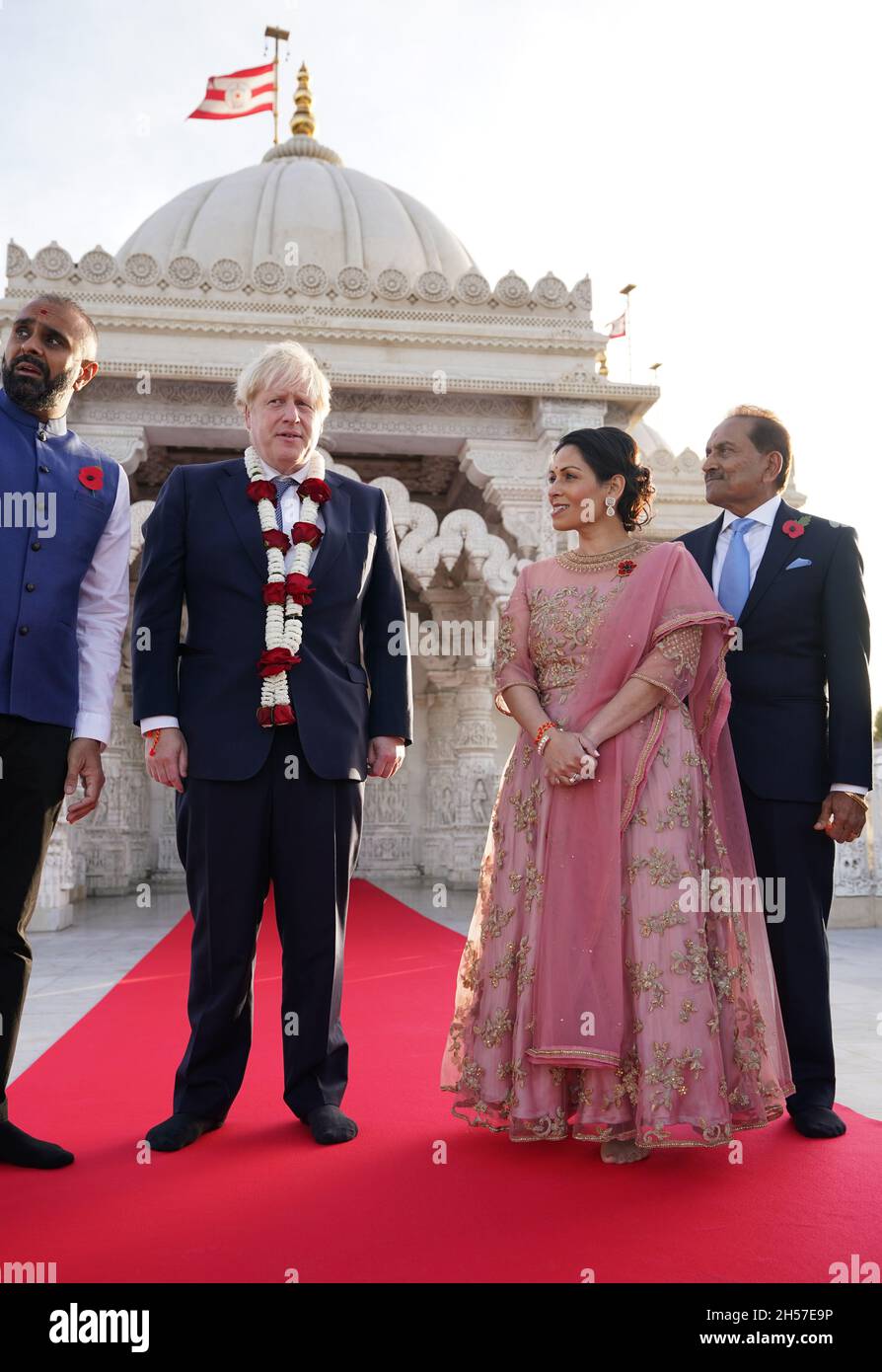 Prime Minister Boris Johnson and Home Secretary Priti Patel with Trustee Sanjay Karia (left) and ...