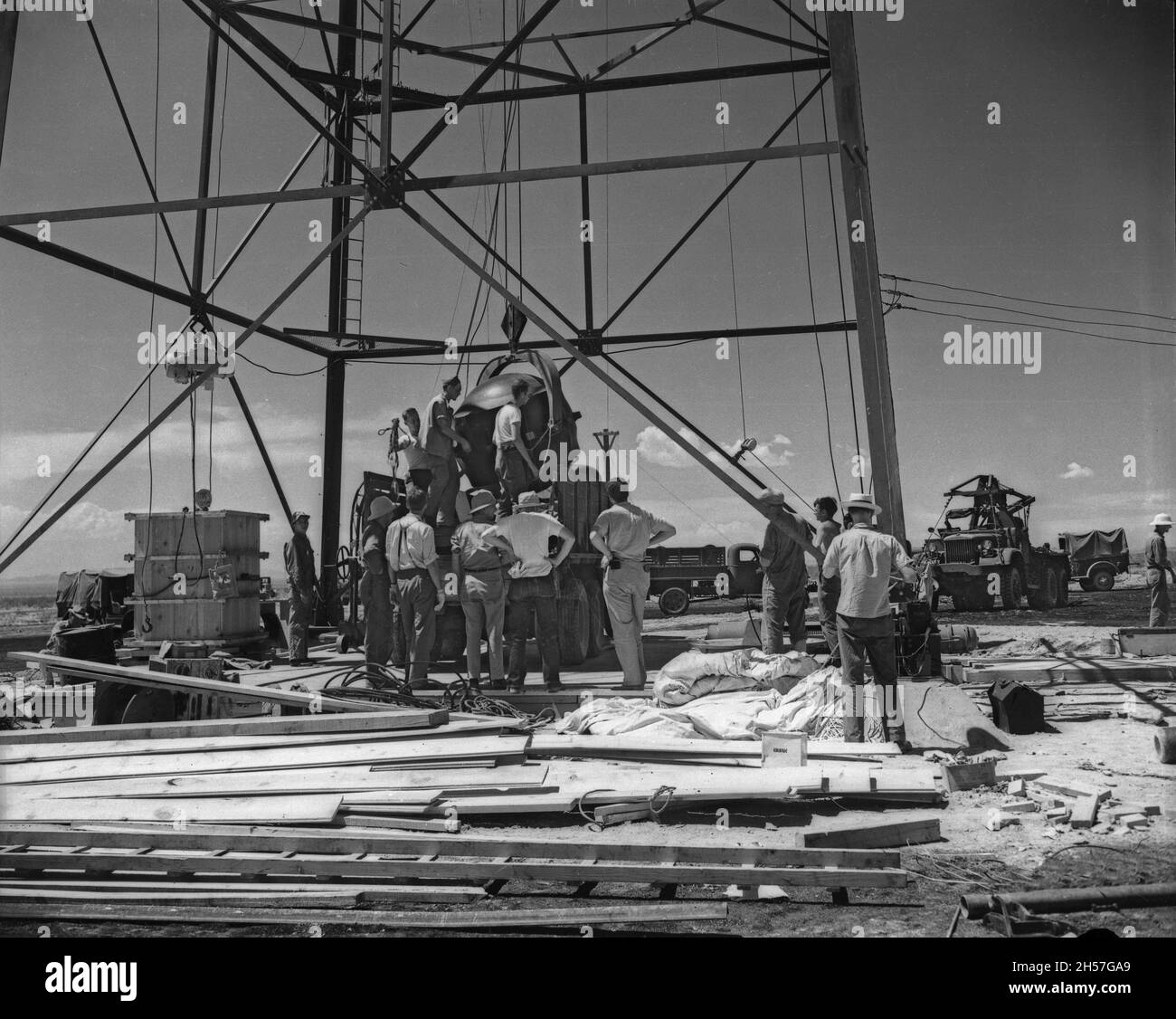 The world's first atomic weapon being readies at the base of the tower ...