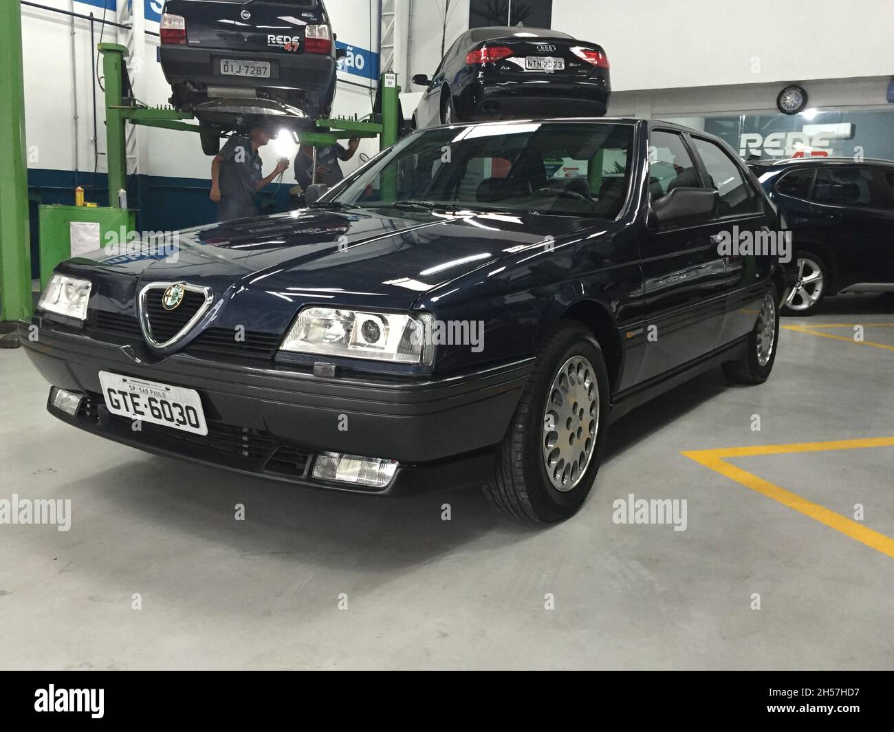 Alfa Romeo 164: Front view, dark blue color, in a workshop. It was ...