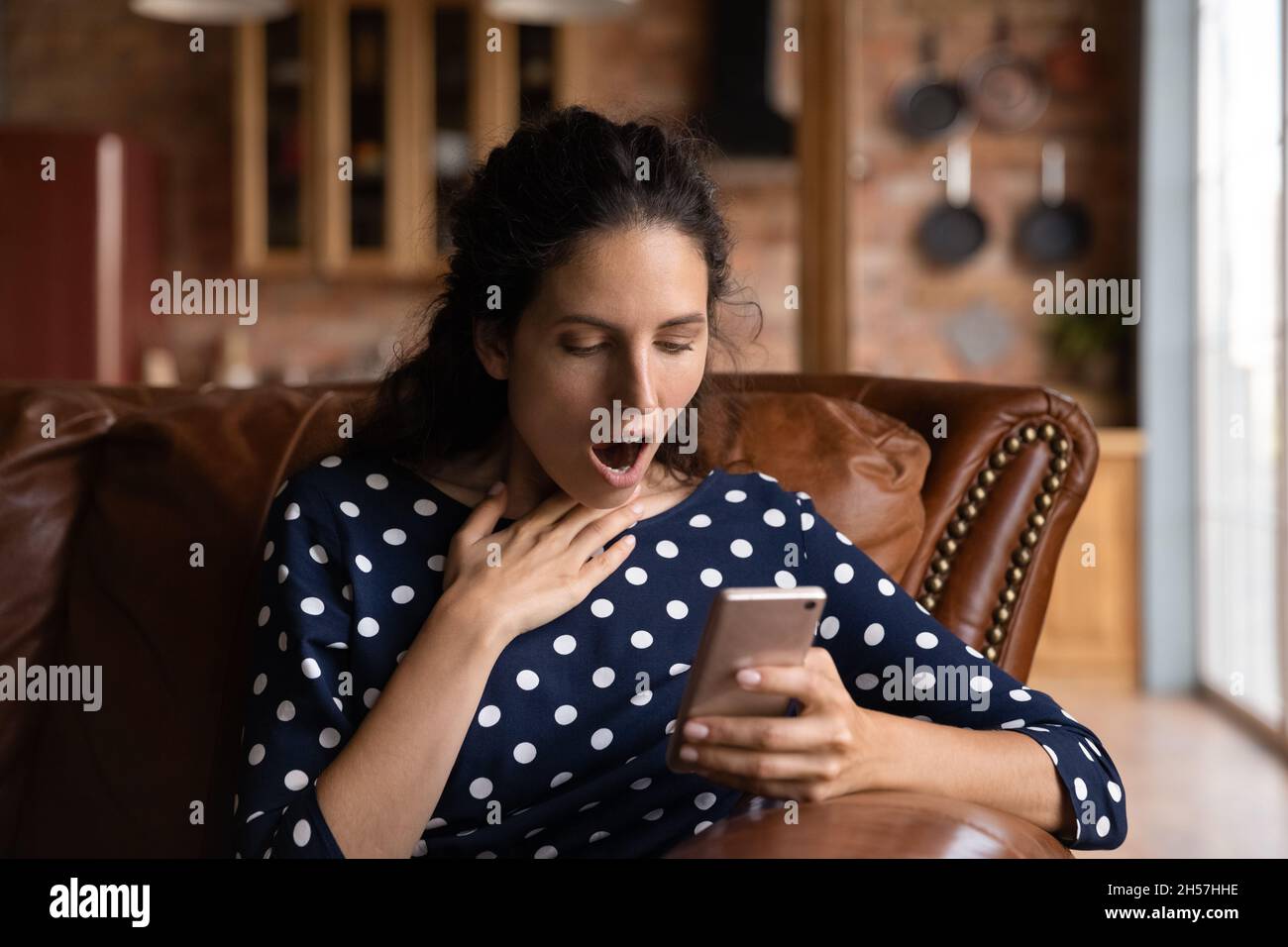 Astonished millennial lady saying omg reading stunning message on cell ...