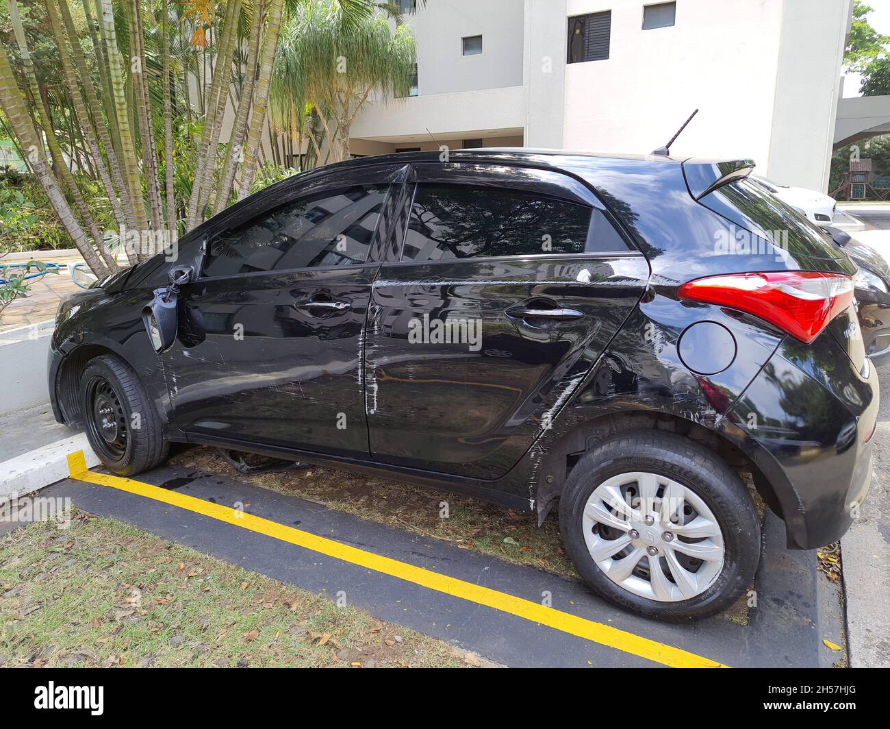 Accident with damaged car with scratches and dents all over the side ...