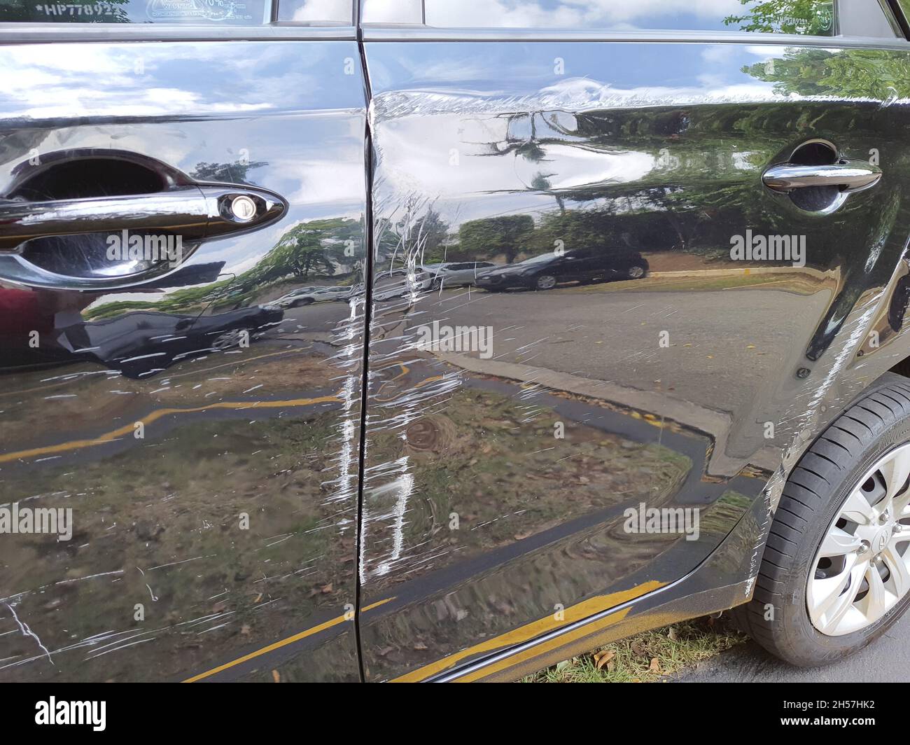 Accident with damaged car with scratches and dents all over the side ...