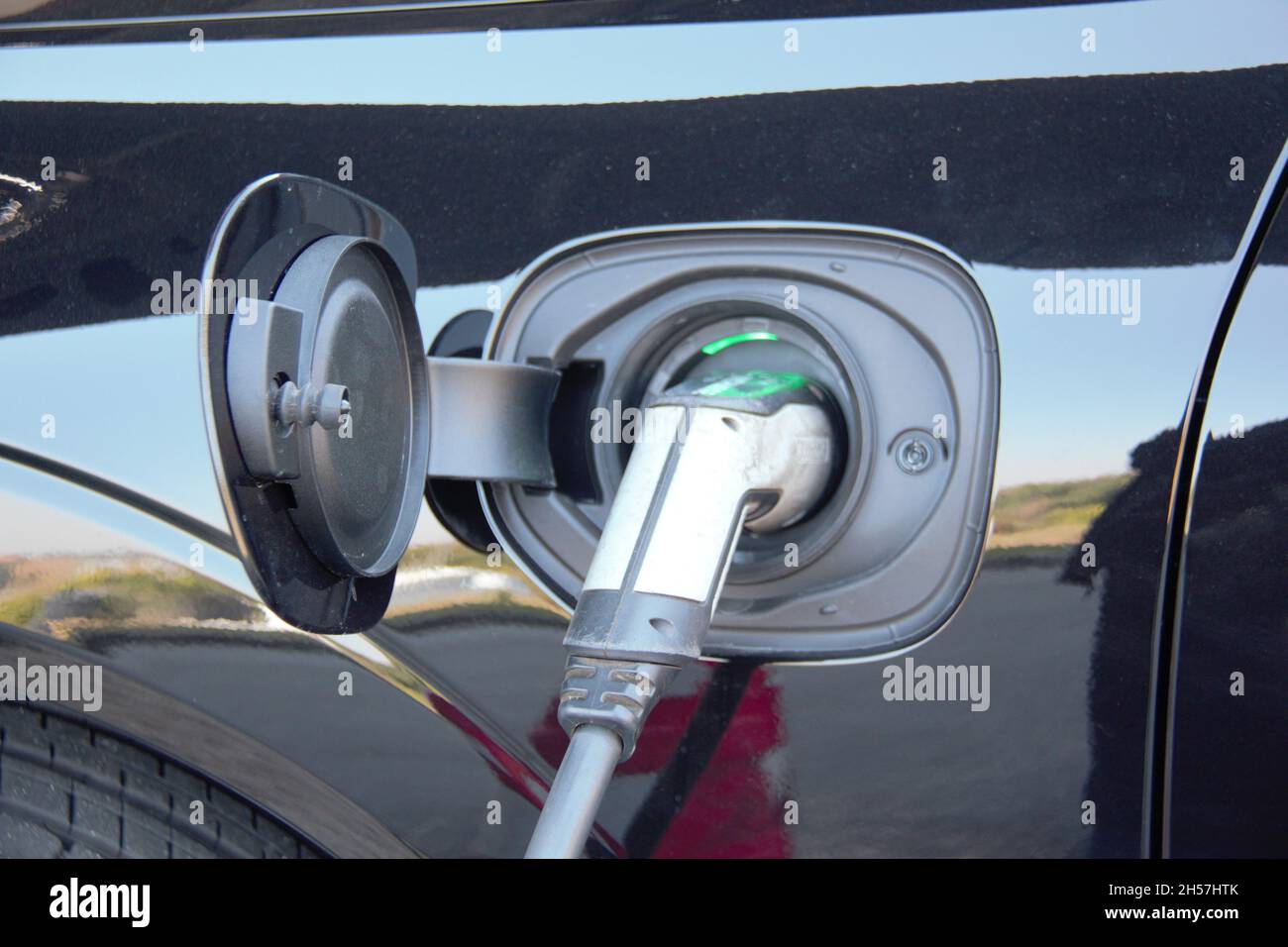 Close-up of a vehicle being powered by an electrical outlet Stock Photo ...