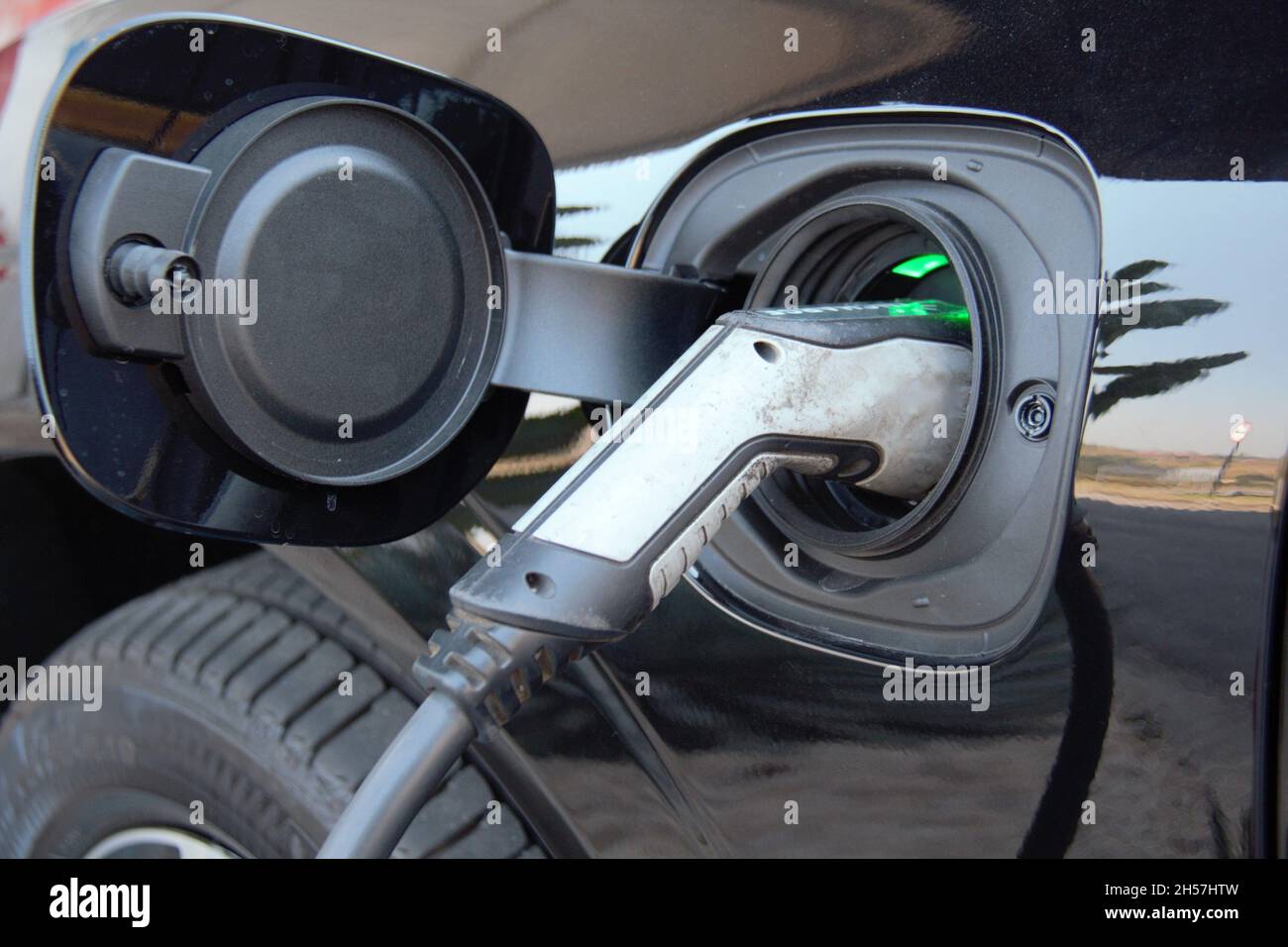 Close-up of a vehicle being powered by an electrical outlet Stock Photo ...