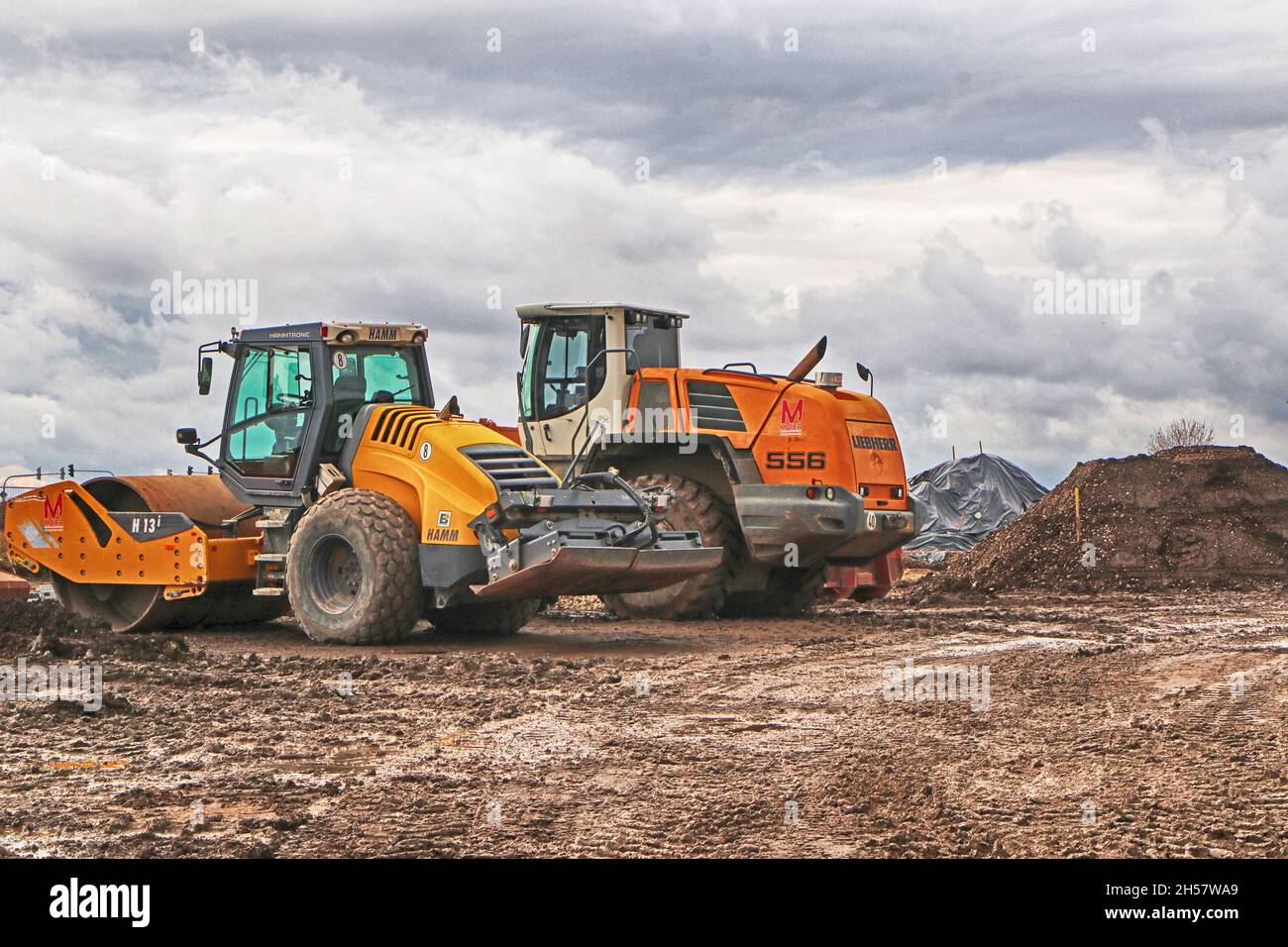 Construction site in development with bulldozers and compactors working ...