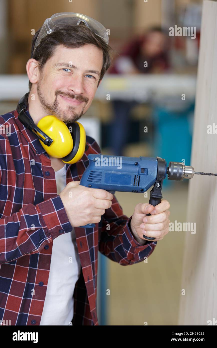 happy electrician or worker in factory Stock Photo - Alamy