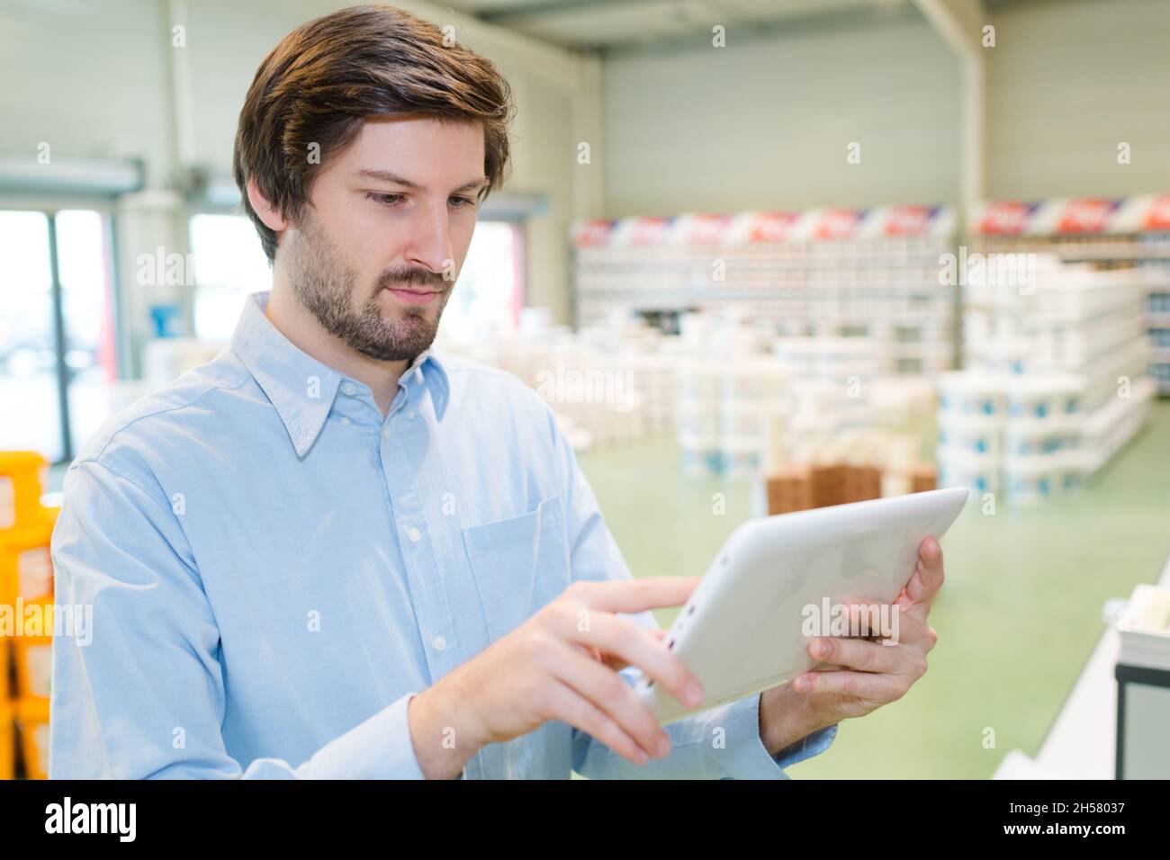 industrial and decorating shop manager using tablet Stock Photo - Alamy
