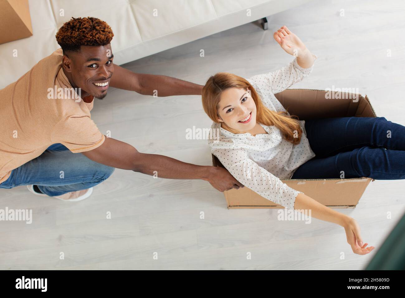 overjoyed couple smiling playful with wife in cardboard box Stock Photo ...