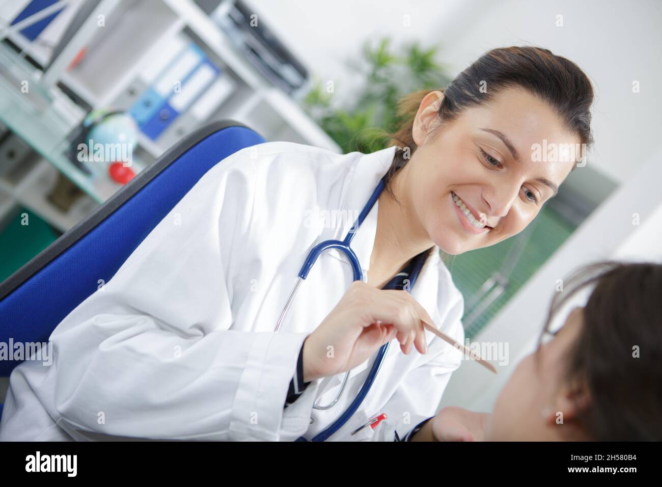 female medicine doctor examining patient Stock Photo - Alamy