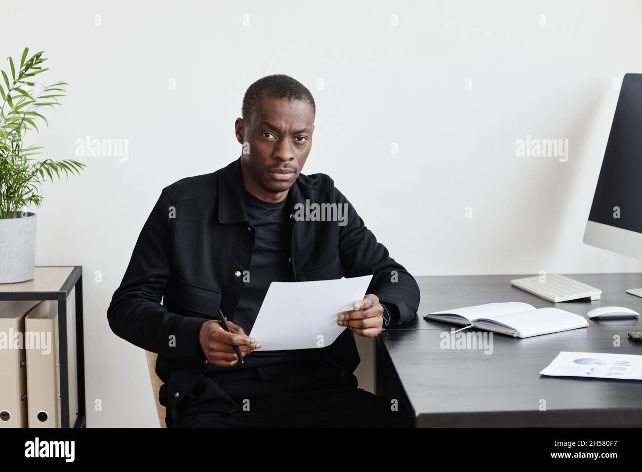 Minimal portrait of successful black businessman working at desk in ...