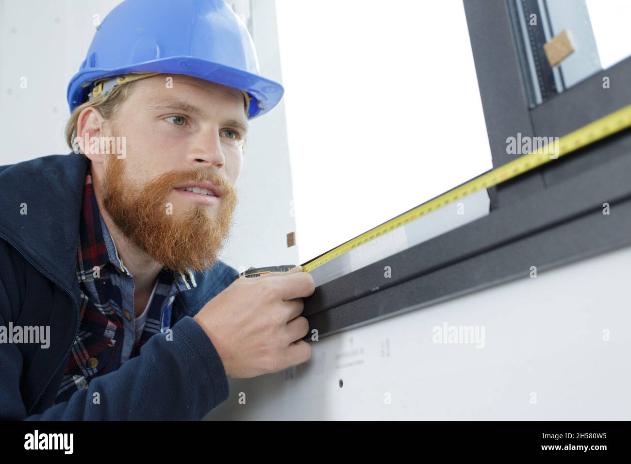 service man measuring window for installation indoors closeup Stock ...