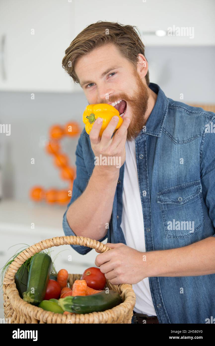 man eating a row pepper Stock Photo - Alamy