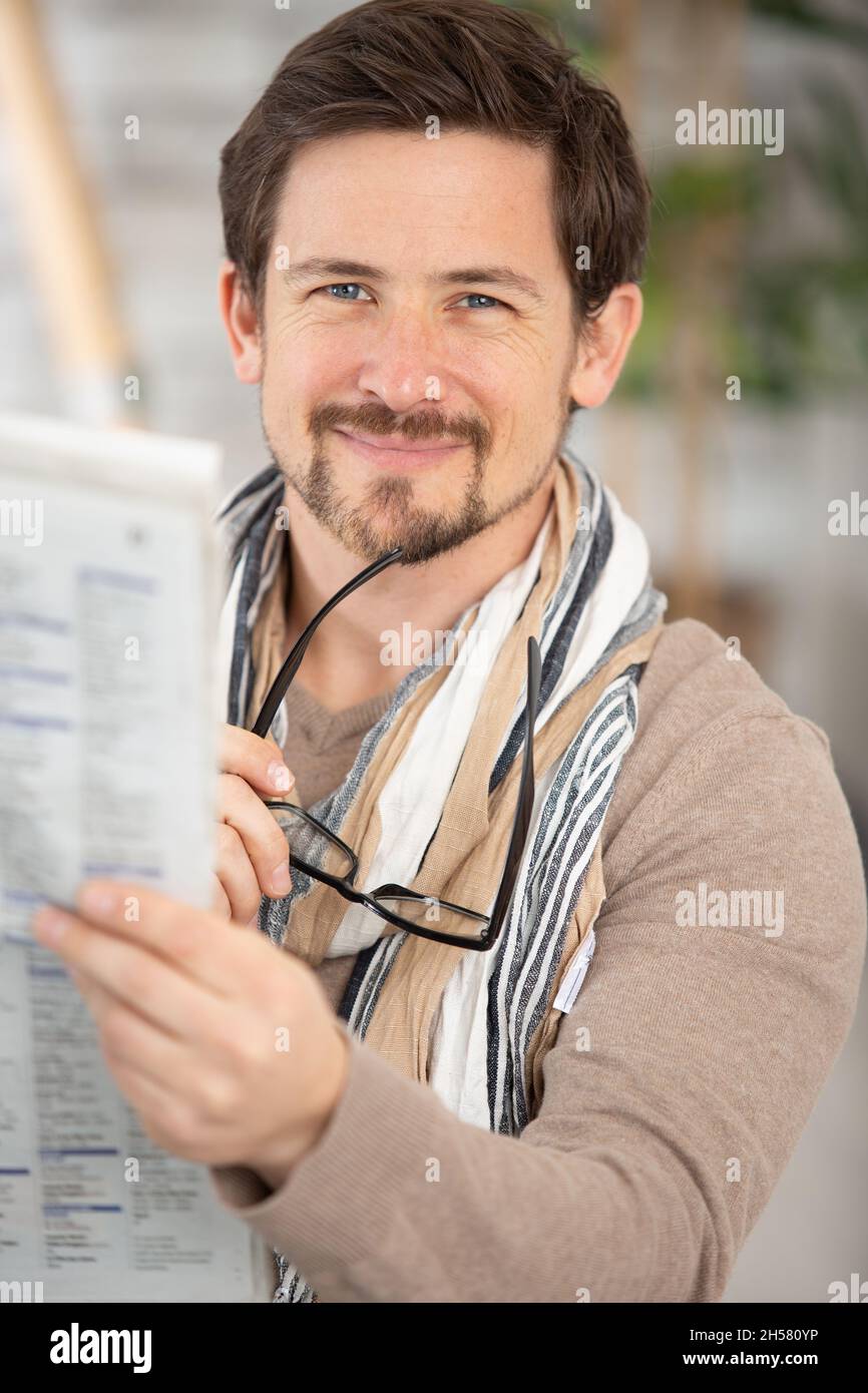 man at home reading newspaper Stock Photo - Alamy