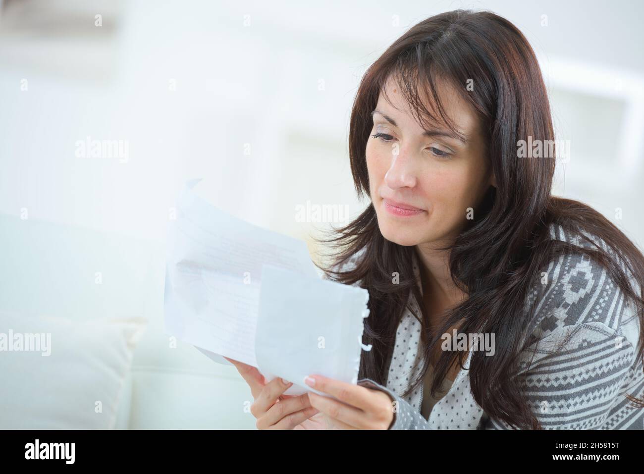 a woman is reading letter Stock Photo - Alamy