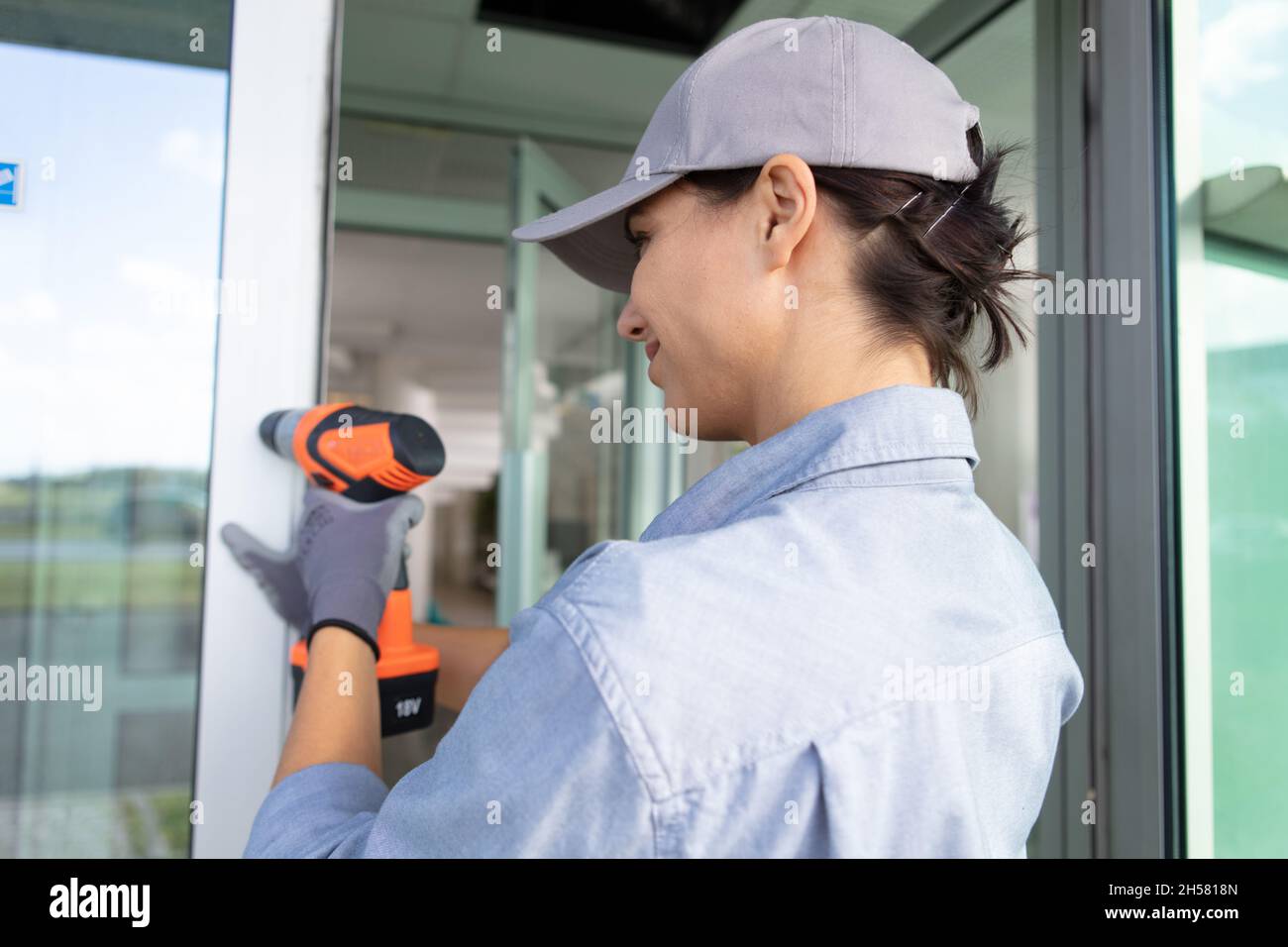 Young woman using drill machine hi-res stock photography and images - Alamy