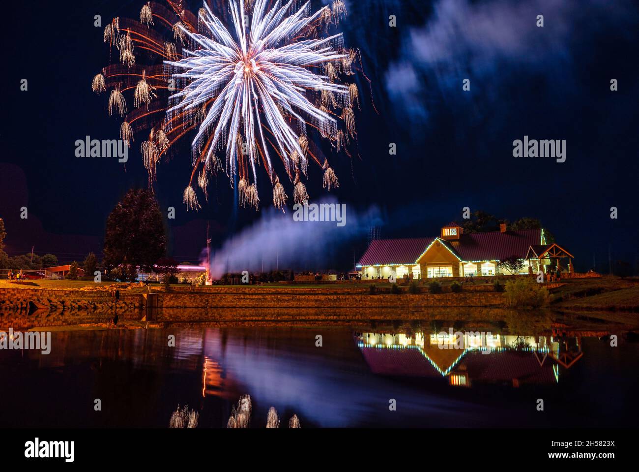 Colorful fireworks in the night sky over the countryside Stock Photo ...
