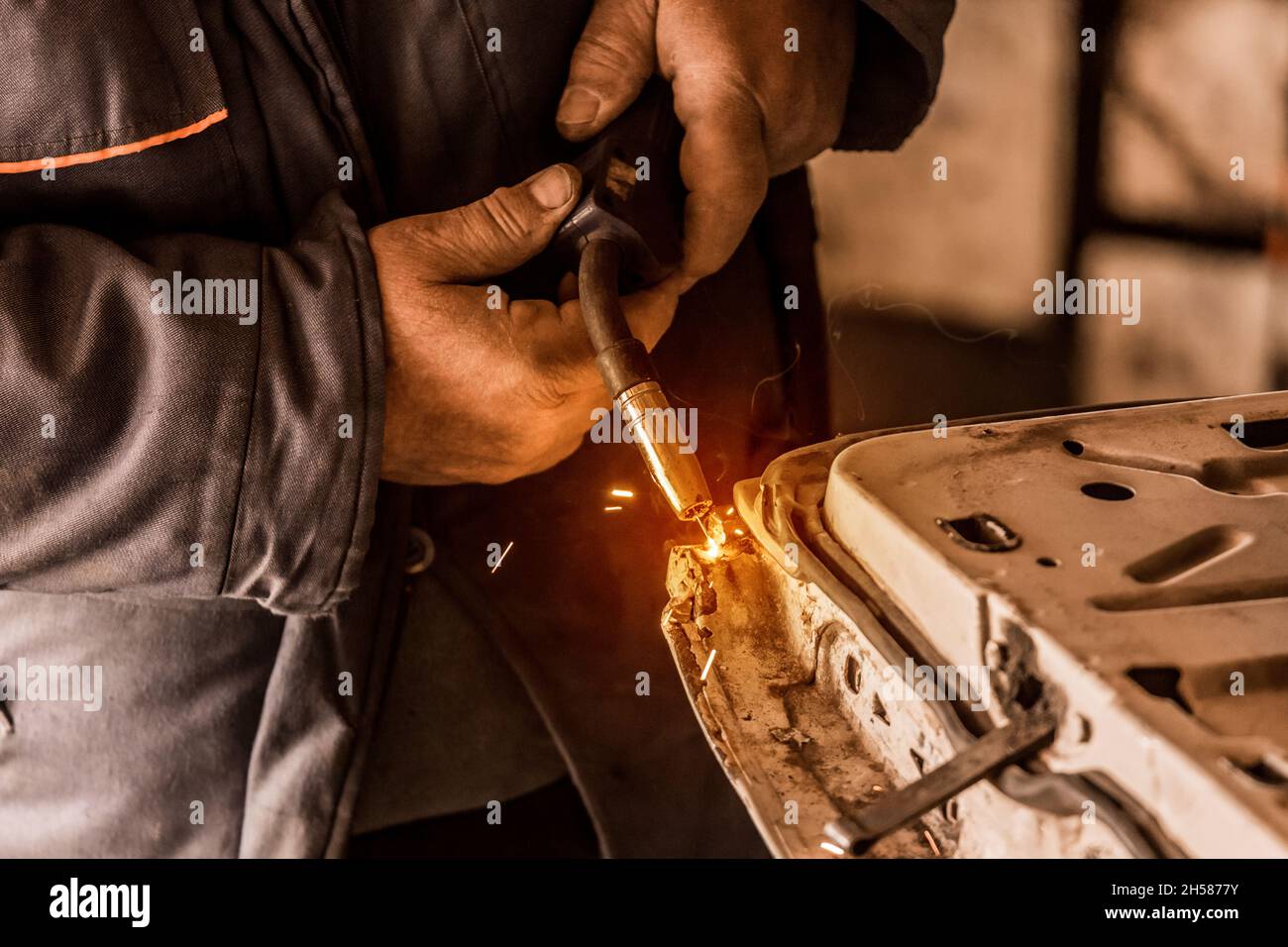 Close up of the process of work on metal, welding of the welder's hand ...