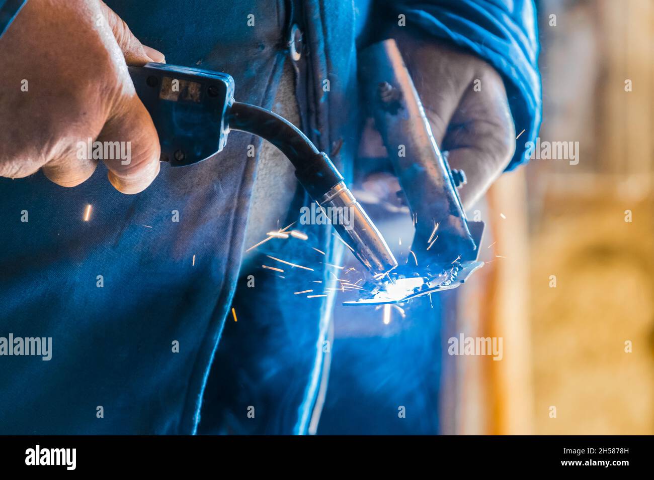 Close-up of welding and metal works in the hands of an industrial ...