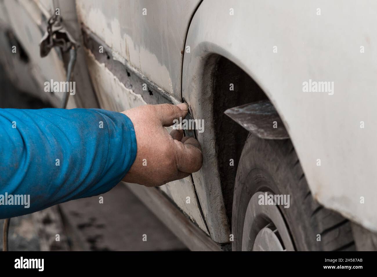 Repair of the rear door of the car. Elimination of the broken body of ...