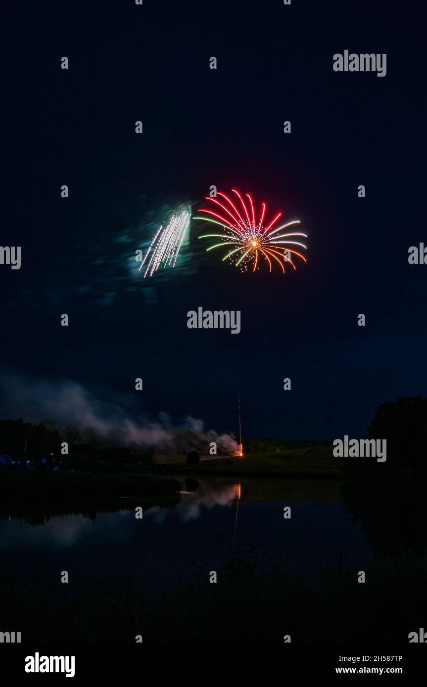 A colorful sun-shaped firework exploded in the sky Stock Photo - Alamy
