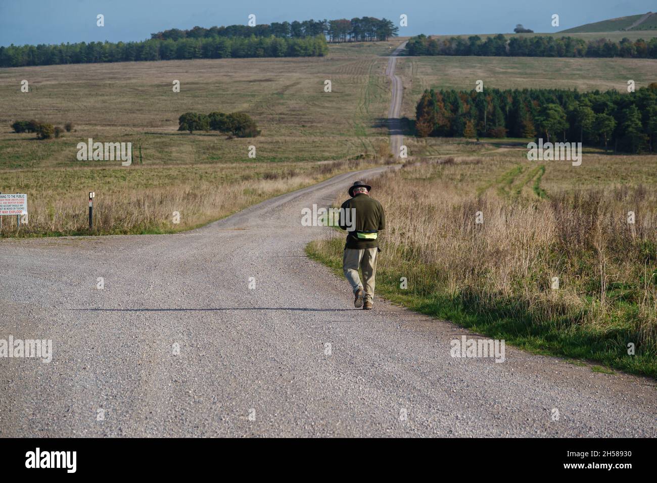 a lone male reading his map whilst hiking across open countryside Stock ...