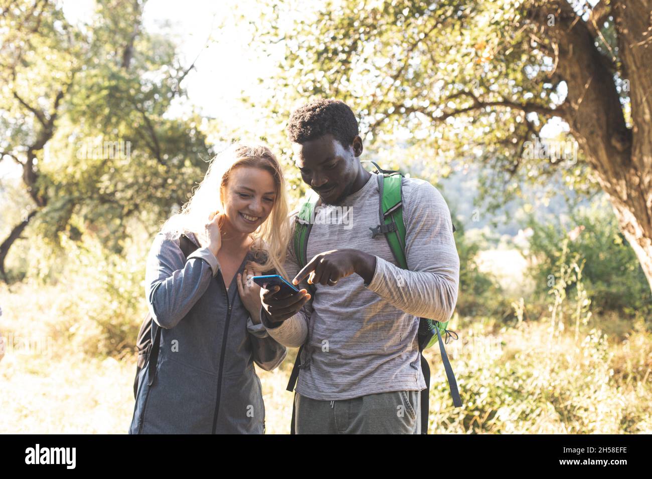 The young couple are looking for a path in the forest Stock Photo - Alamy