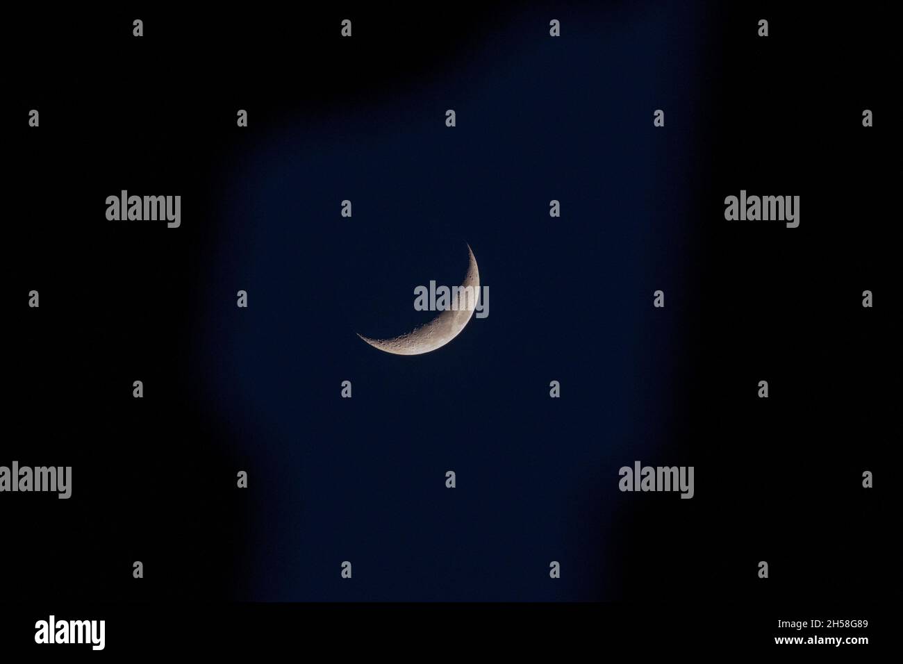 A beautiful image of a half-moon with a blue and black background ...