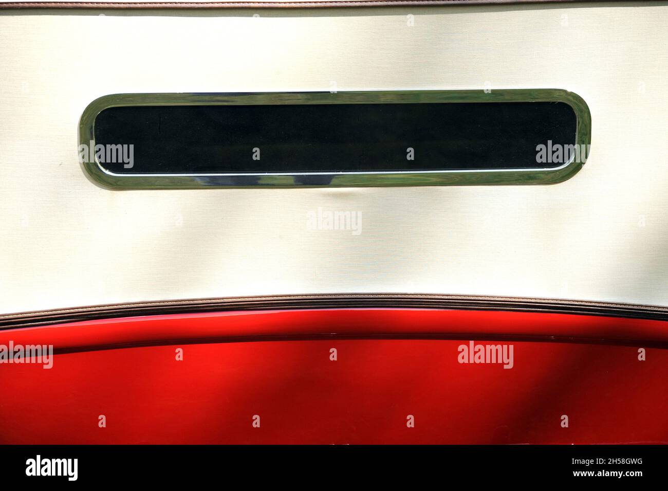 The letter hole on a white and red wall - mail slot background Stock ...