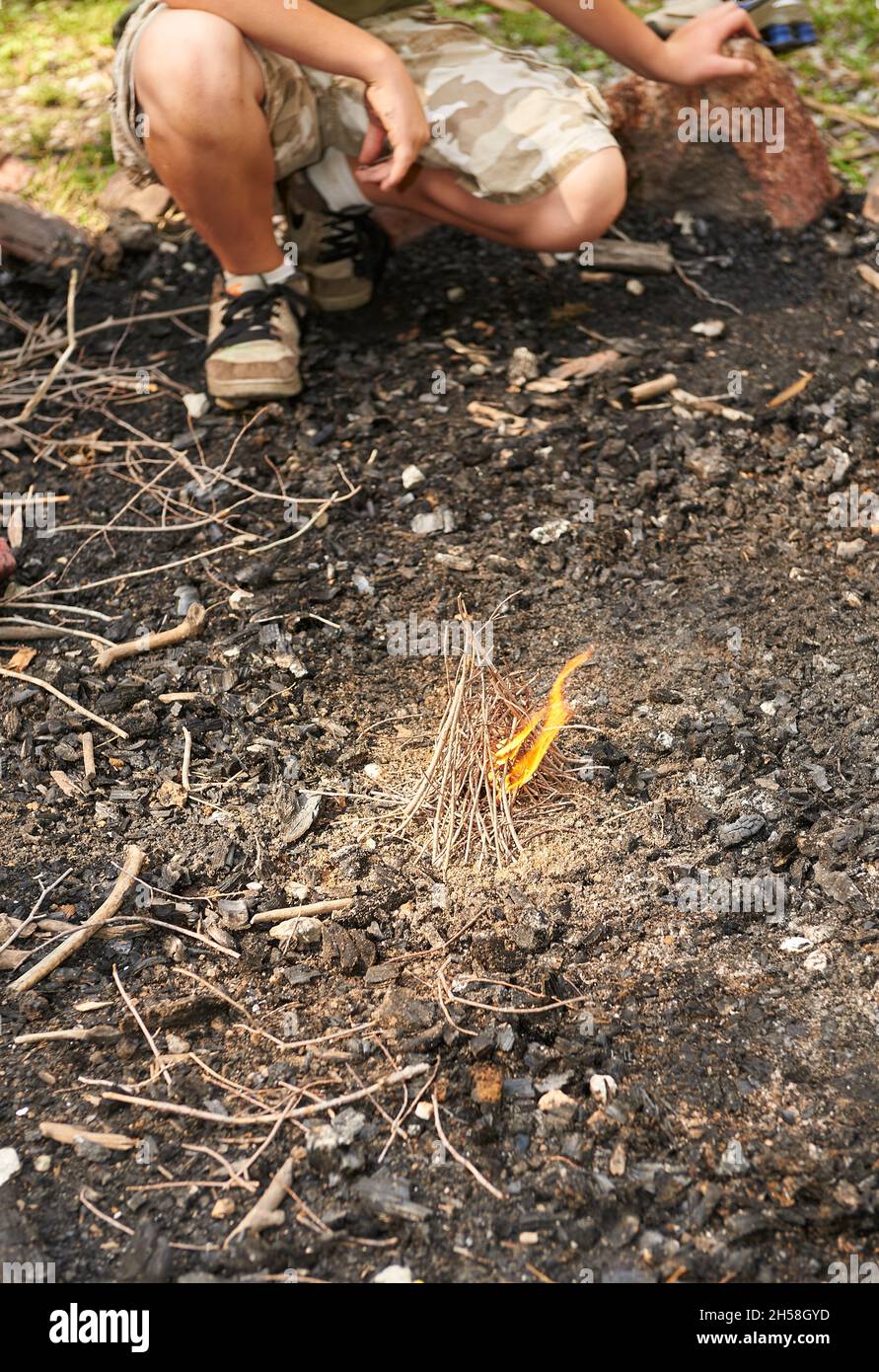 Building a camp fire for meals at summer camp Stock Photo - Alamy