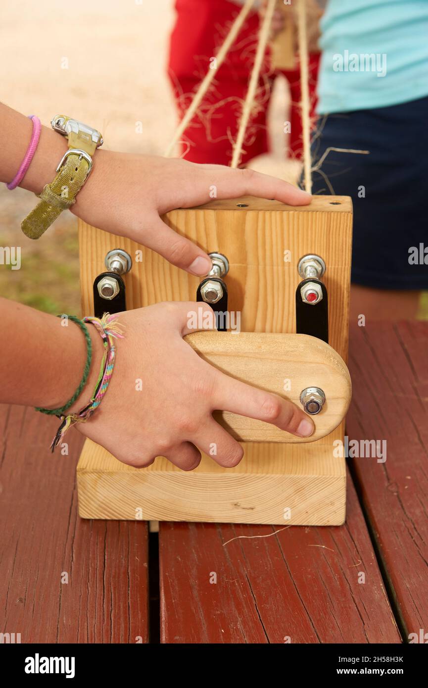 making rope using hand machine at summer camp Stock Photo - Alamy
