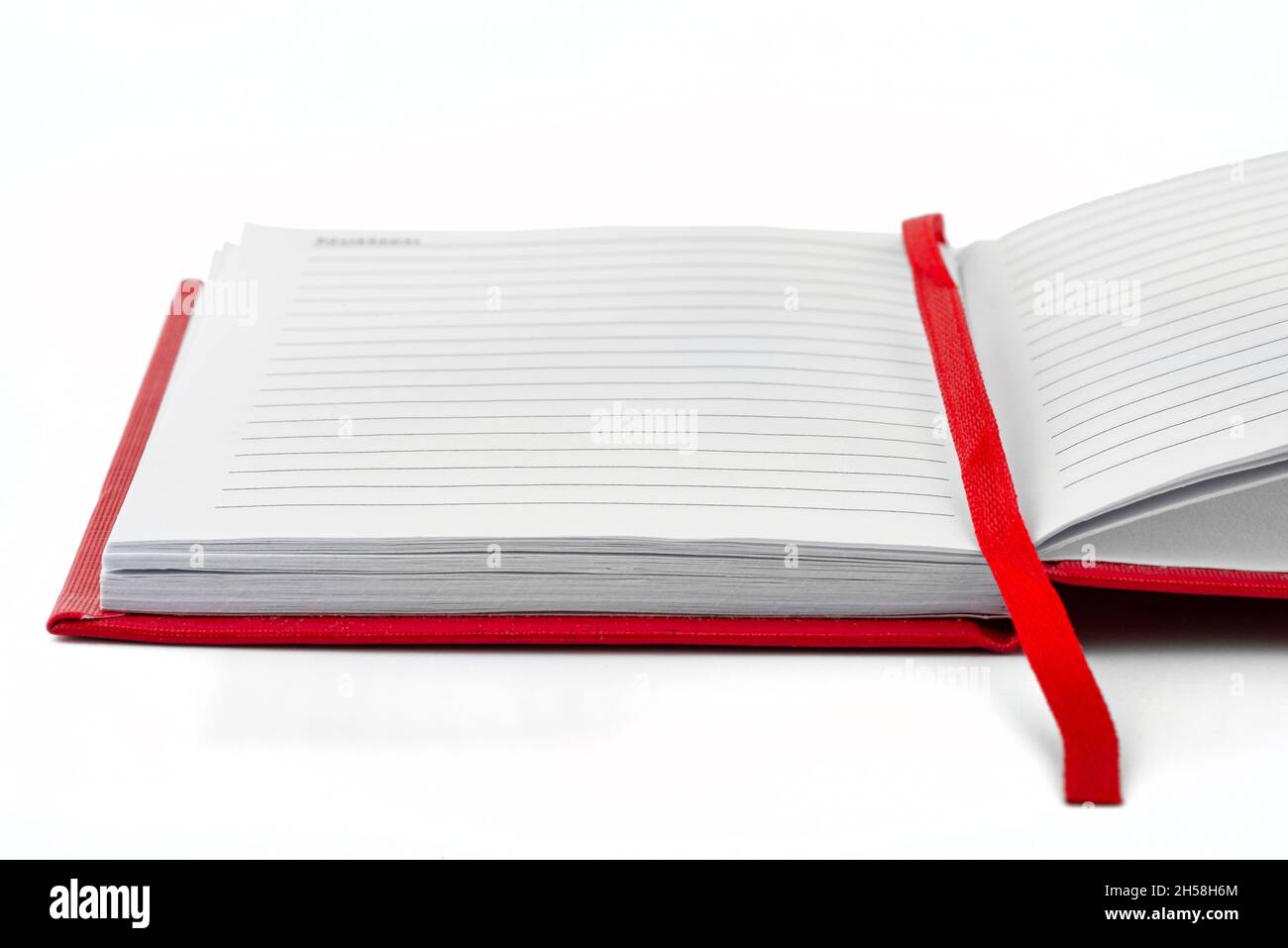 Open red notebook with black lines with ribbon, isolated on a white ...
