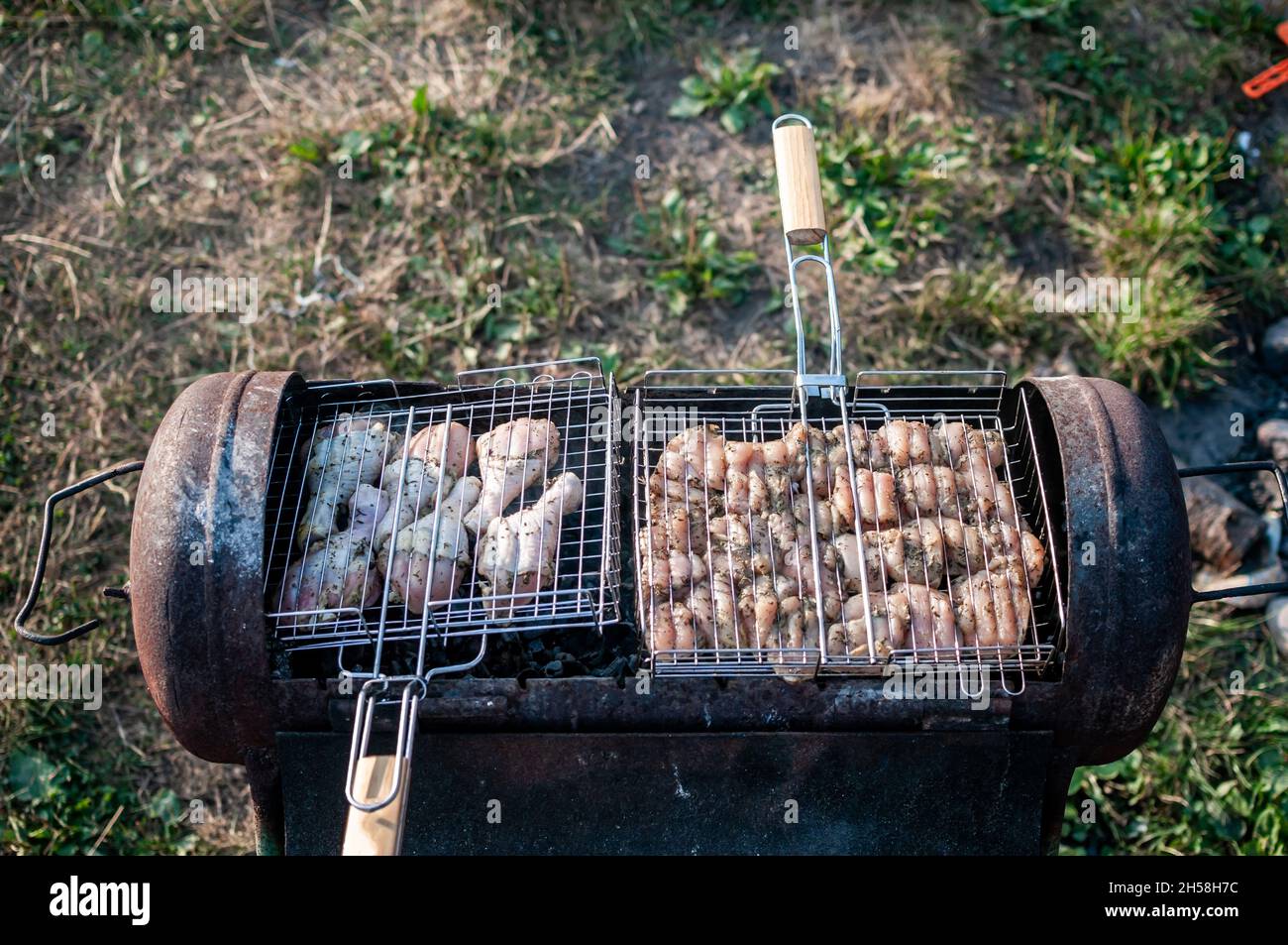 grilled meat skewers chicken the meat holder over fire burned churcoal ...
